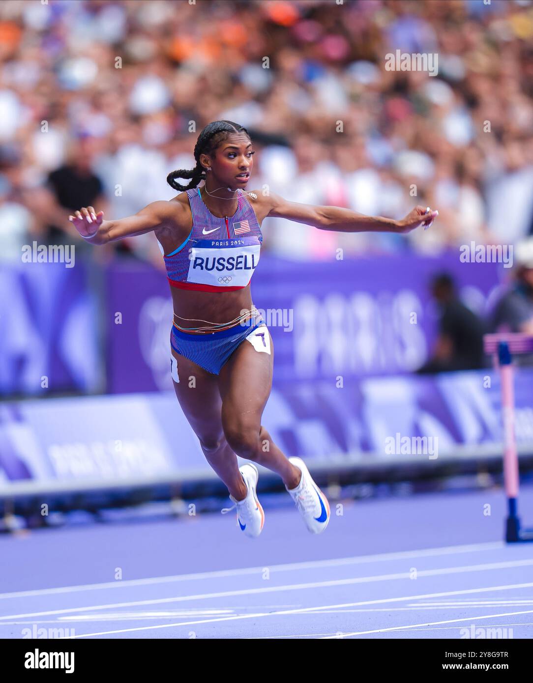 Masai Russell participating in the 100 meters hurdles at the Paris 2024 ...
