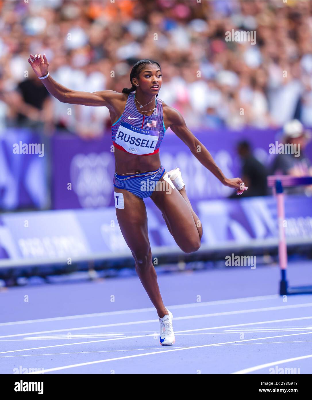 Masai Russell participating in the 100 meters hurdles at the Paris 2024 ...