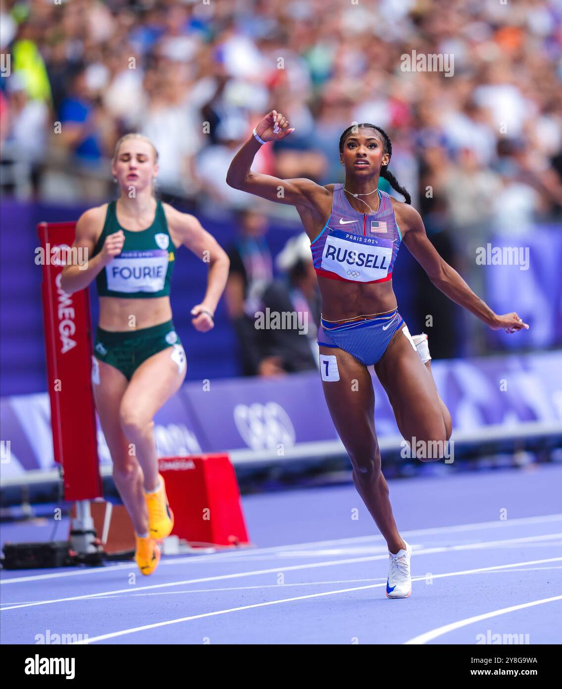 Masai Russell participating in the 100 meters hurdles at the Paris 2024 ...