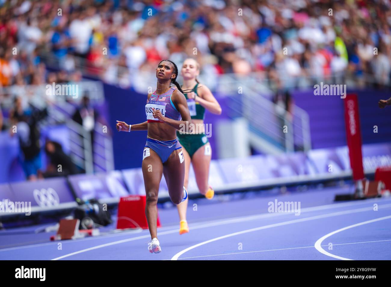 Masai Russell participating in the 100 meters hurdles at the Paris 2024 ...