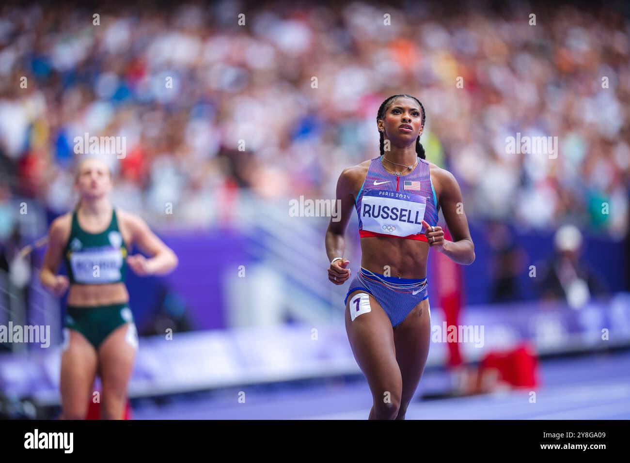 Masai Russell participating in the 100 meters hurdles at the Paris 2024 ...