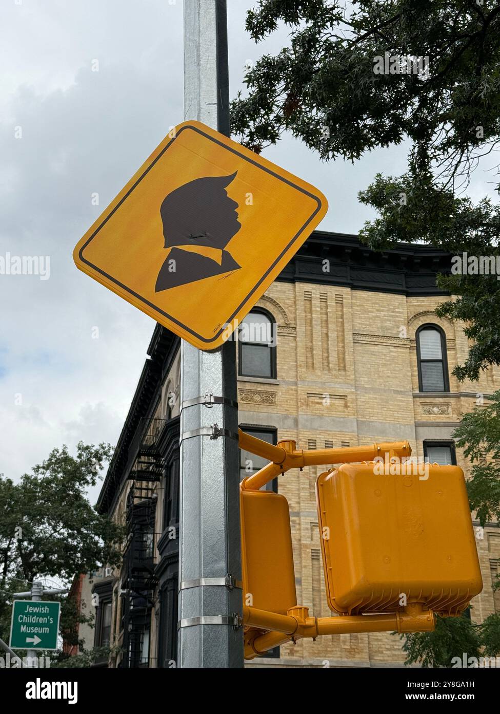 Someone put up a yellow street sign with the likeness of presidential ...