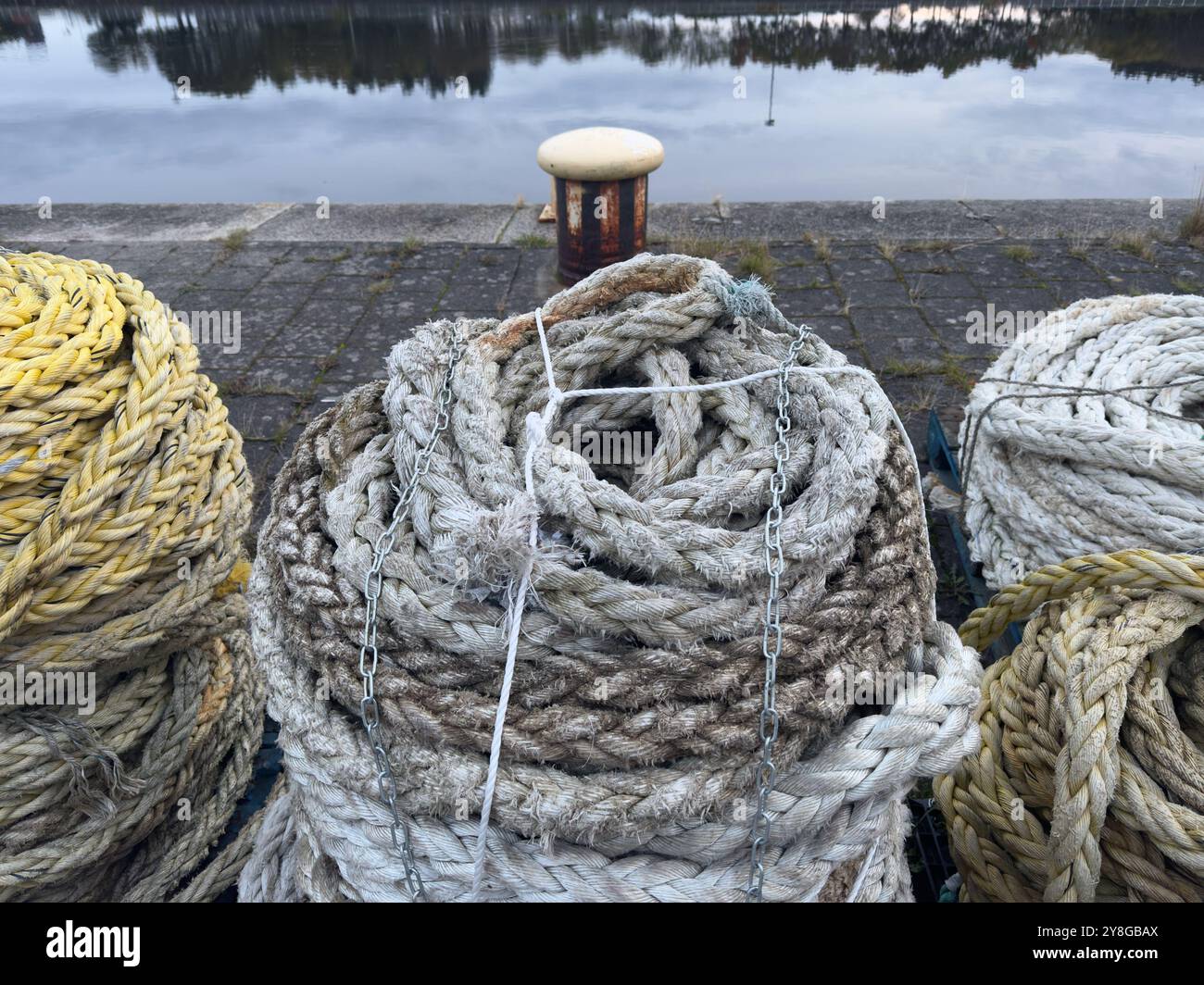 Ship rope in roll at harbour for secure mooring of boat Stock Photo - Alamy