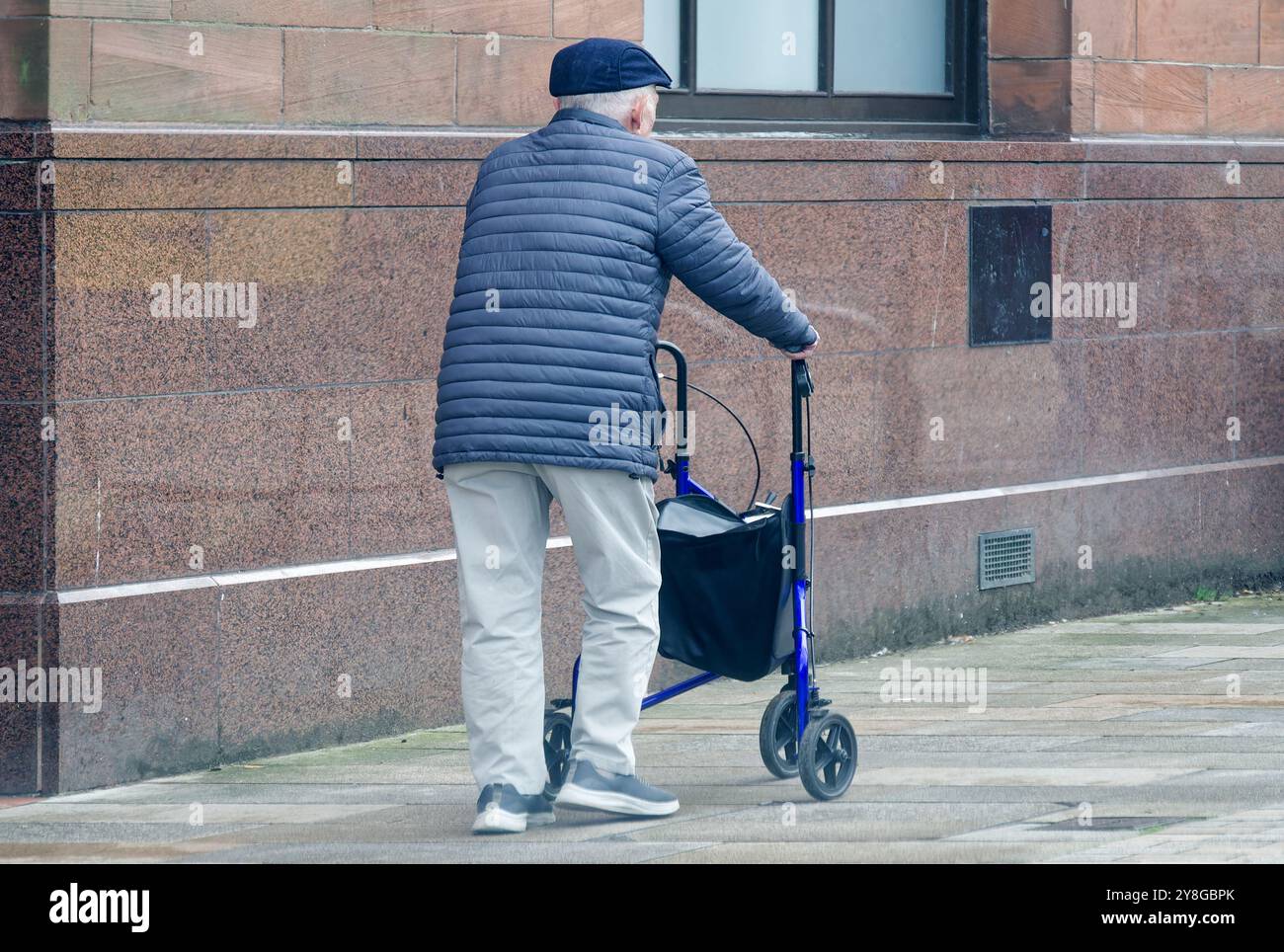 Senior elderly vulnerable person using walking frame for mobility Stock ...