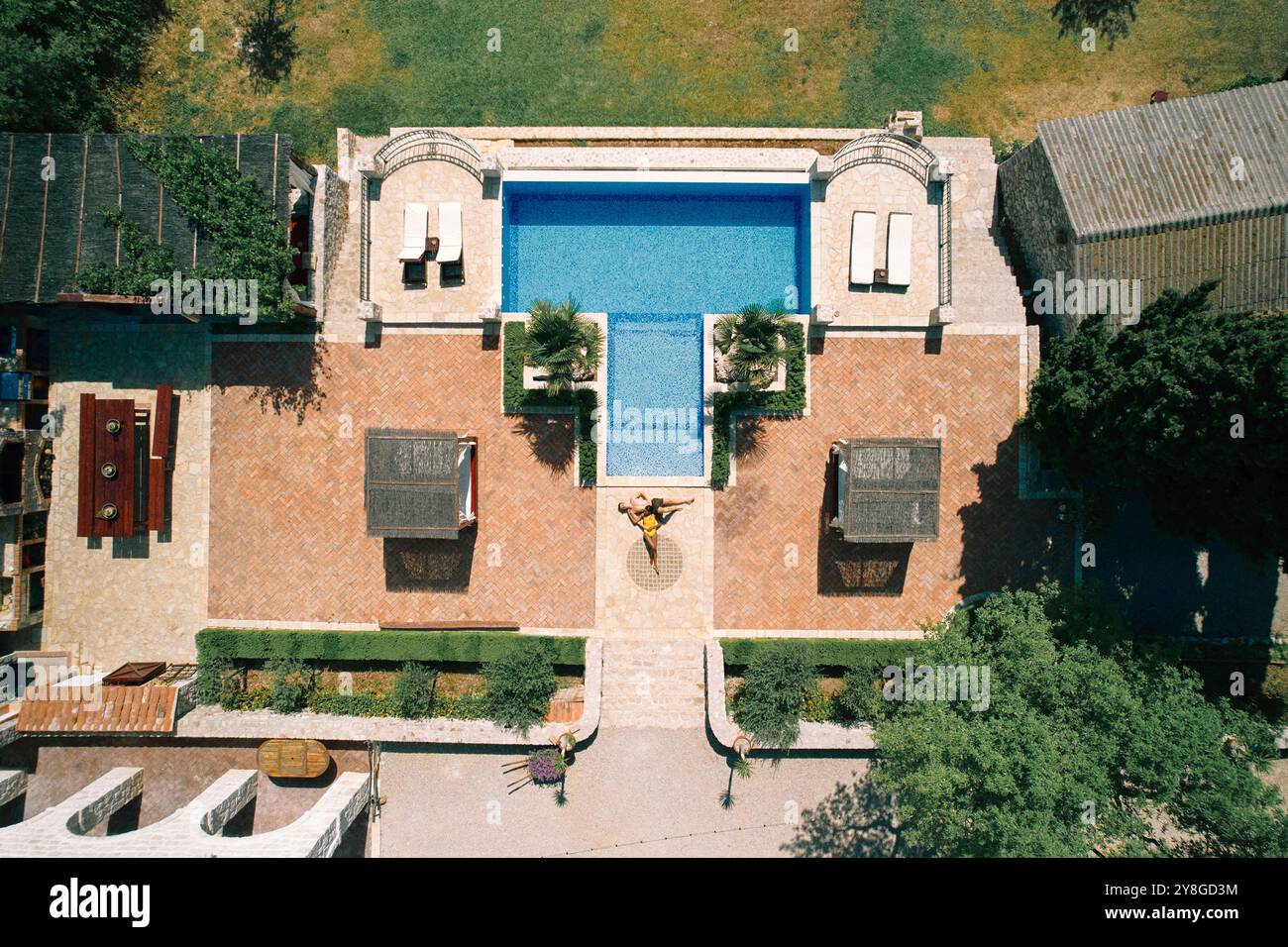 Woman laid her head on man stomach while lying sunbathing by the pool ...