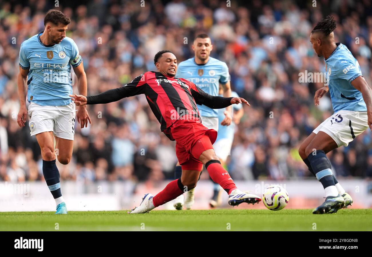 Fulham's Kenny Tete (centre) battles with Manchester City's Ruben Dias ...