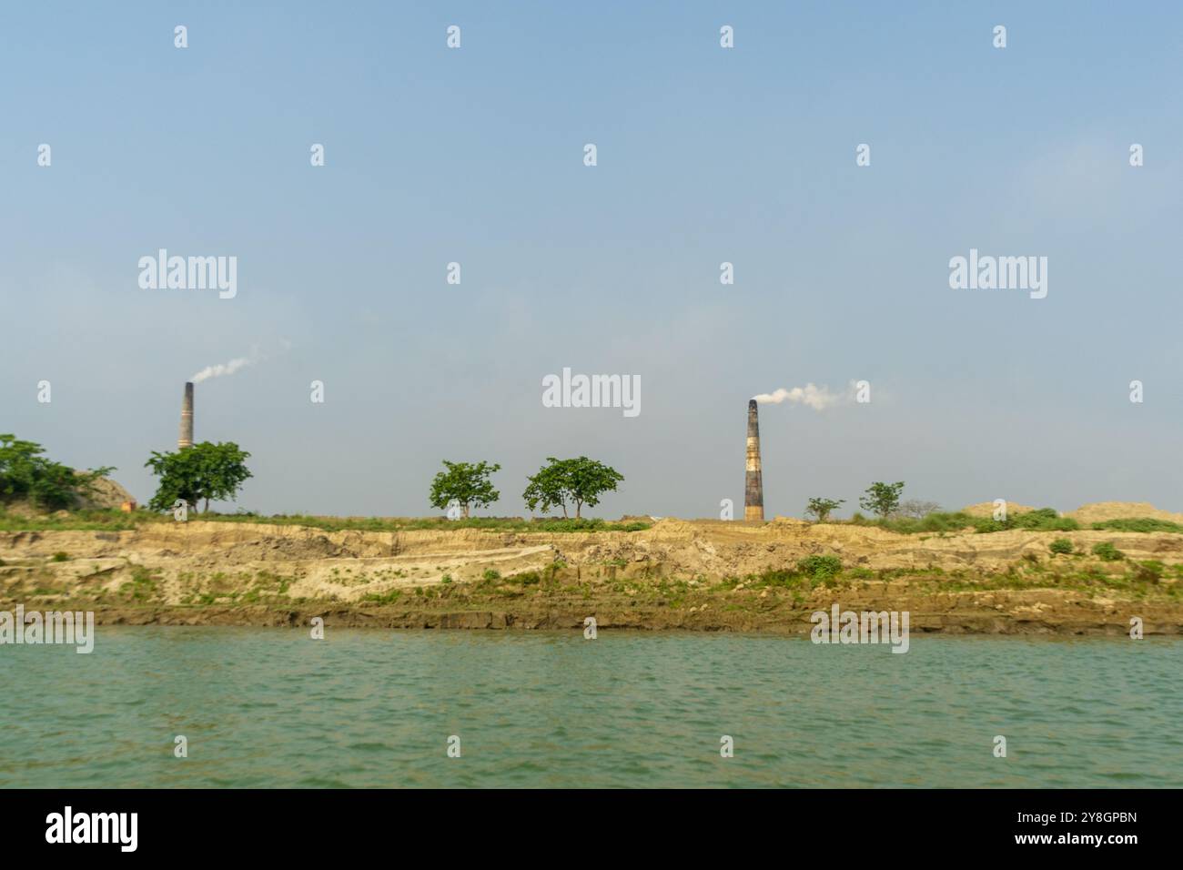 Smoking chimneys of brick factory on banks of Ganges (Padma) River ...