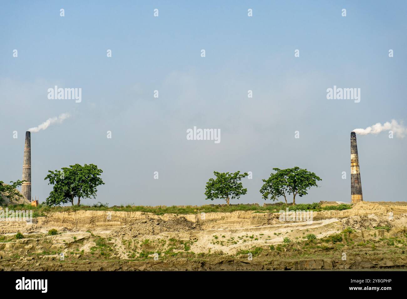 Smoking chimneys of brick factory on banks of Ganges (Padma) River ...