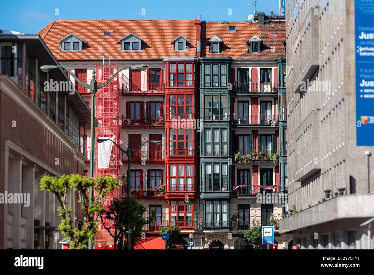Typical facade of residential buildings with balconies and bay windows ...