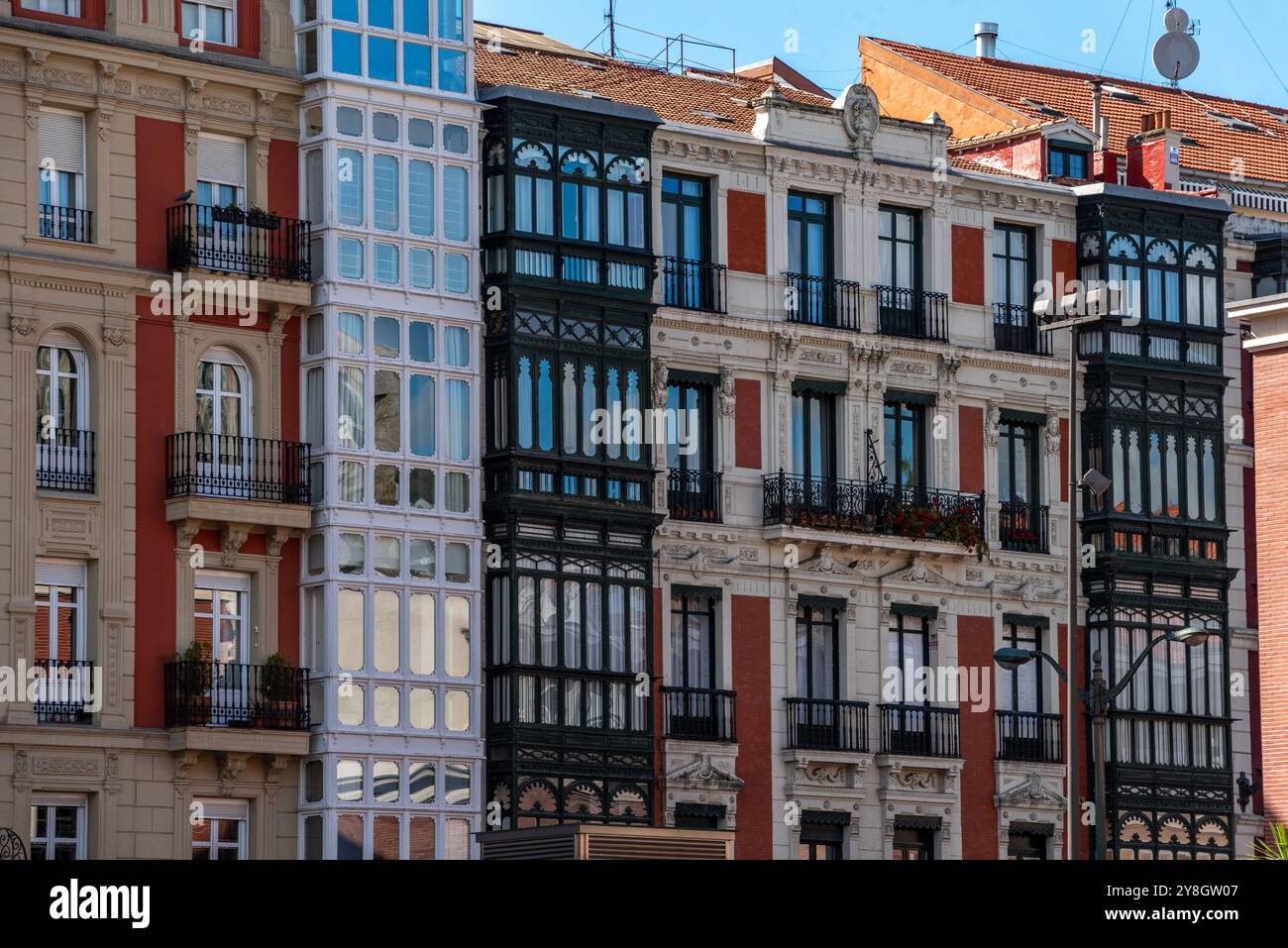 Typical facade of residential buildings with balconies and bay windows ...