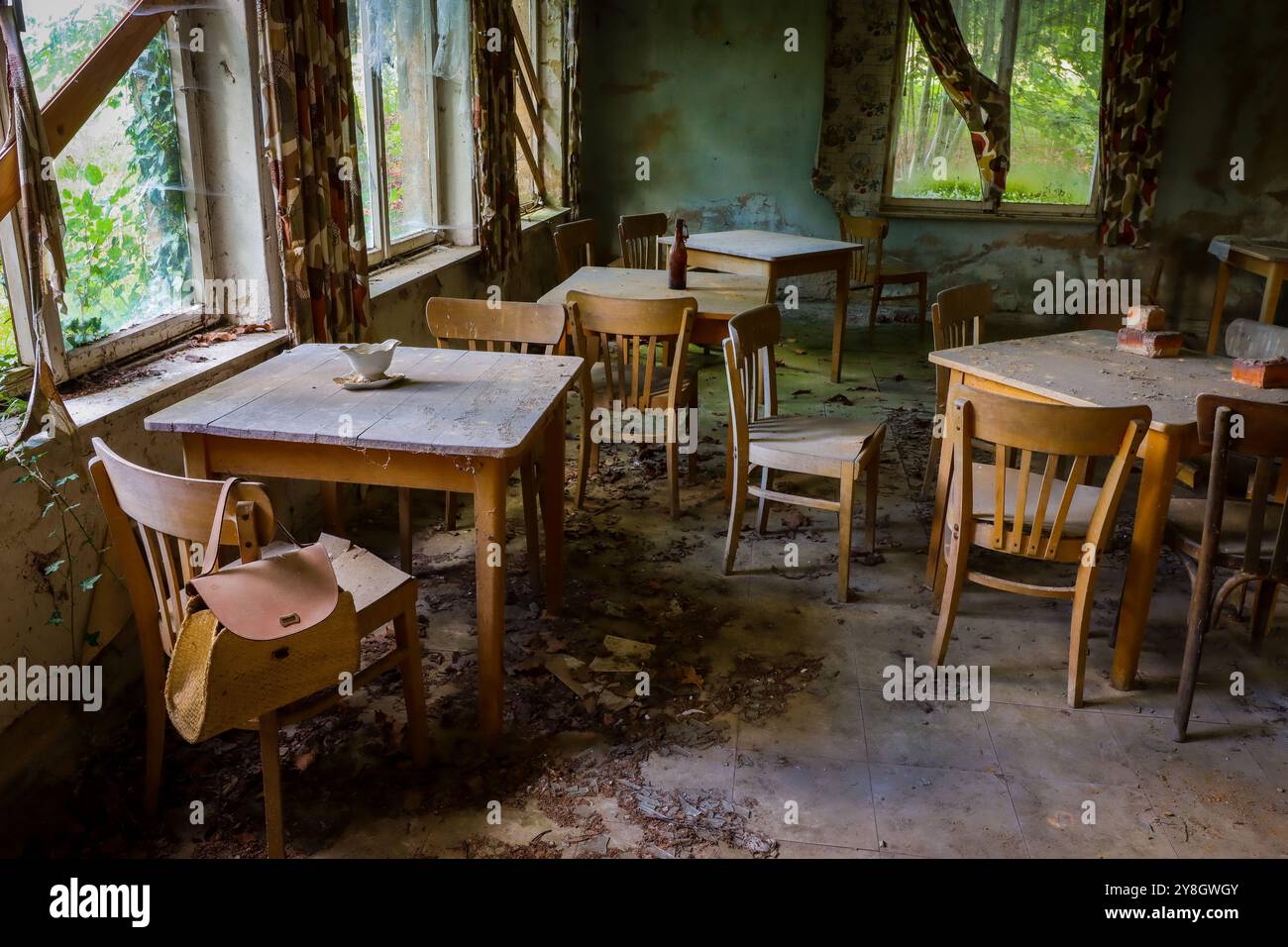 abandoned chairs and tables in a lost place restaurant Stock Photo - Alamy