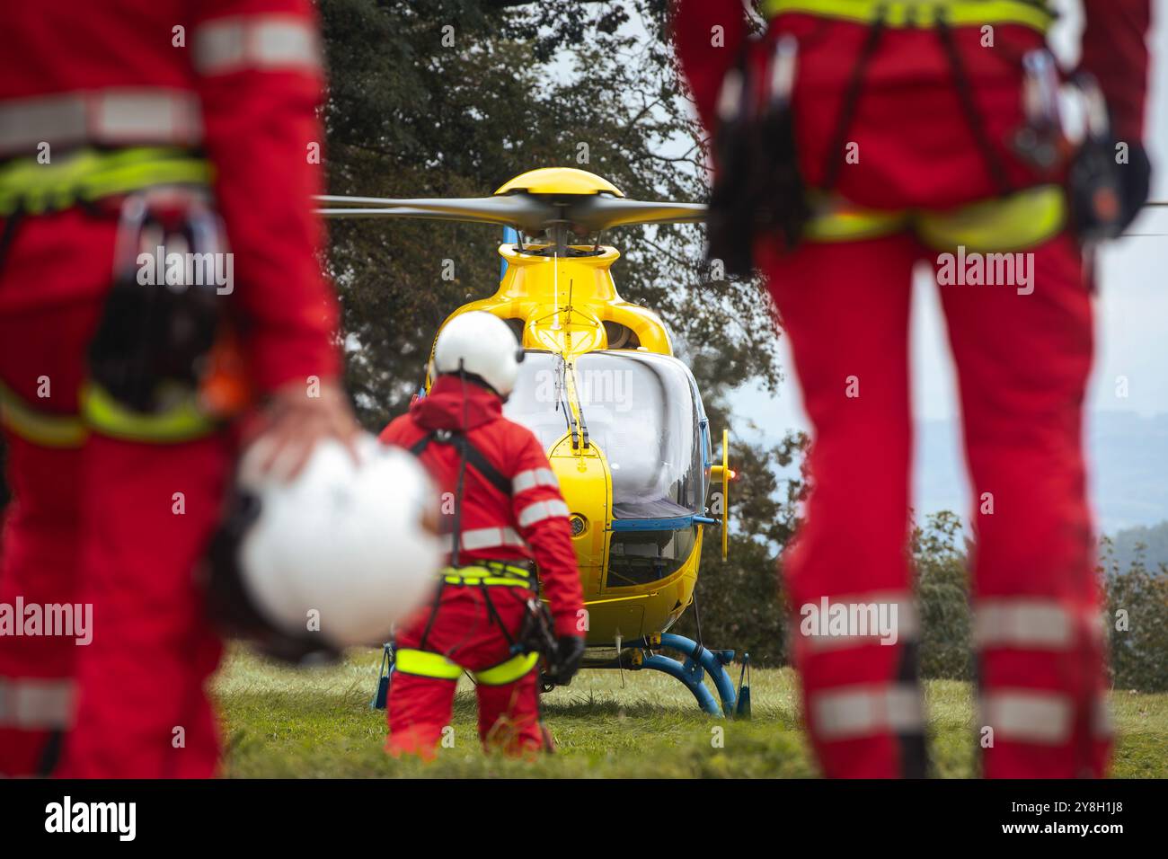Rear view of team of emergency medical service. Doctor and paramedics ...