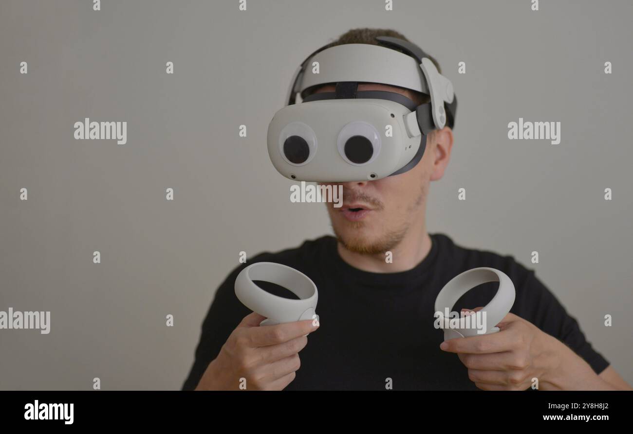 A Young Man Playing using Visual Reality Glasses with eye stickers. VR ...