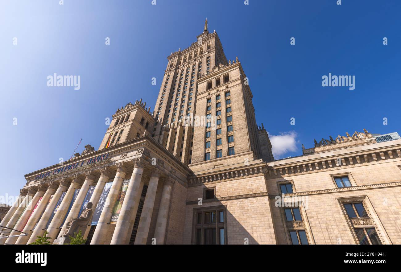 The Palace of Culture and Science stands tall against a clear blue sky ...