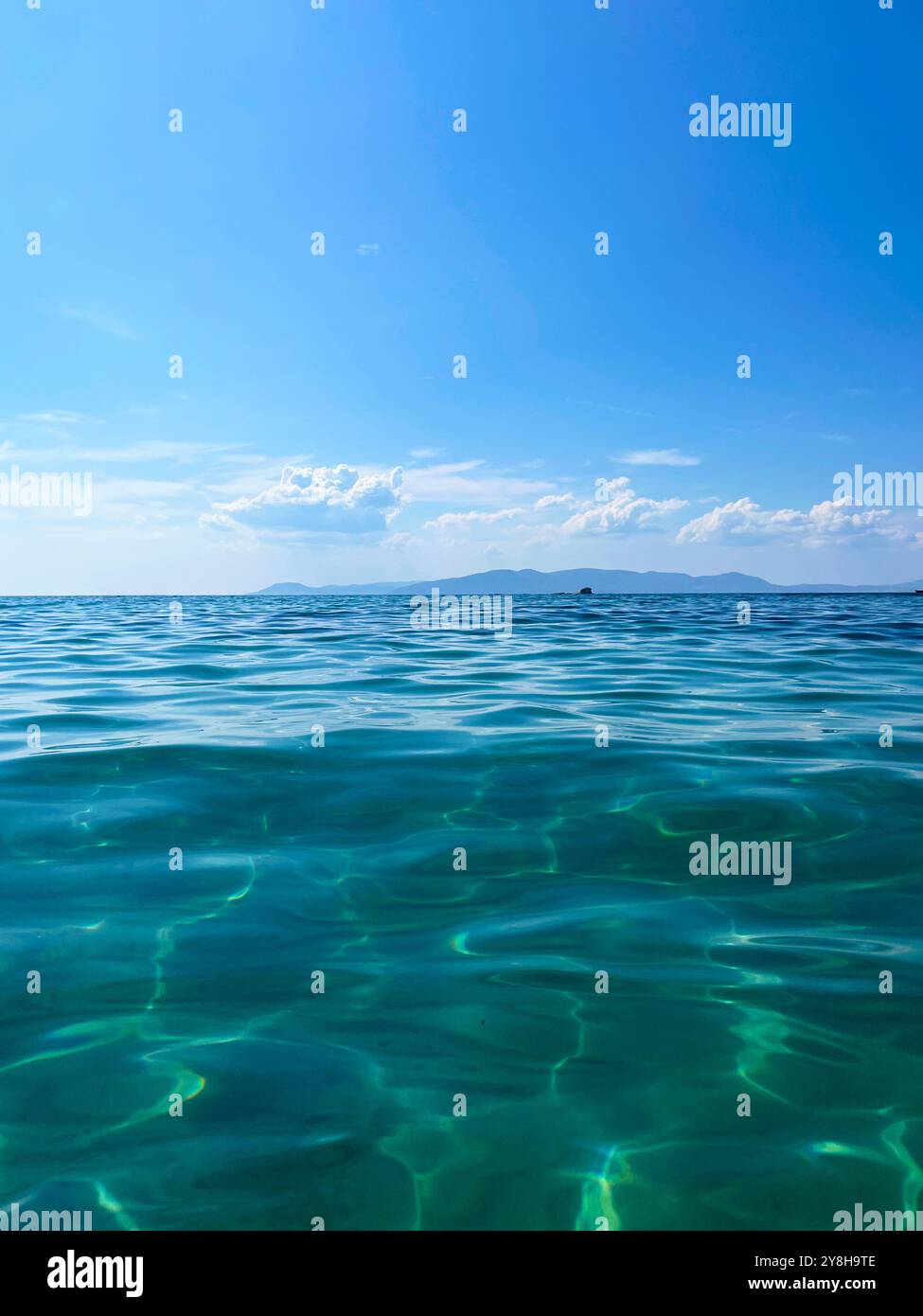 Vertical photo of of sea with half underwater view and cloudy sky as a ...