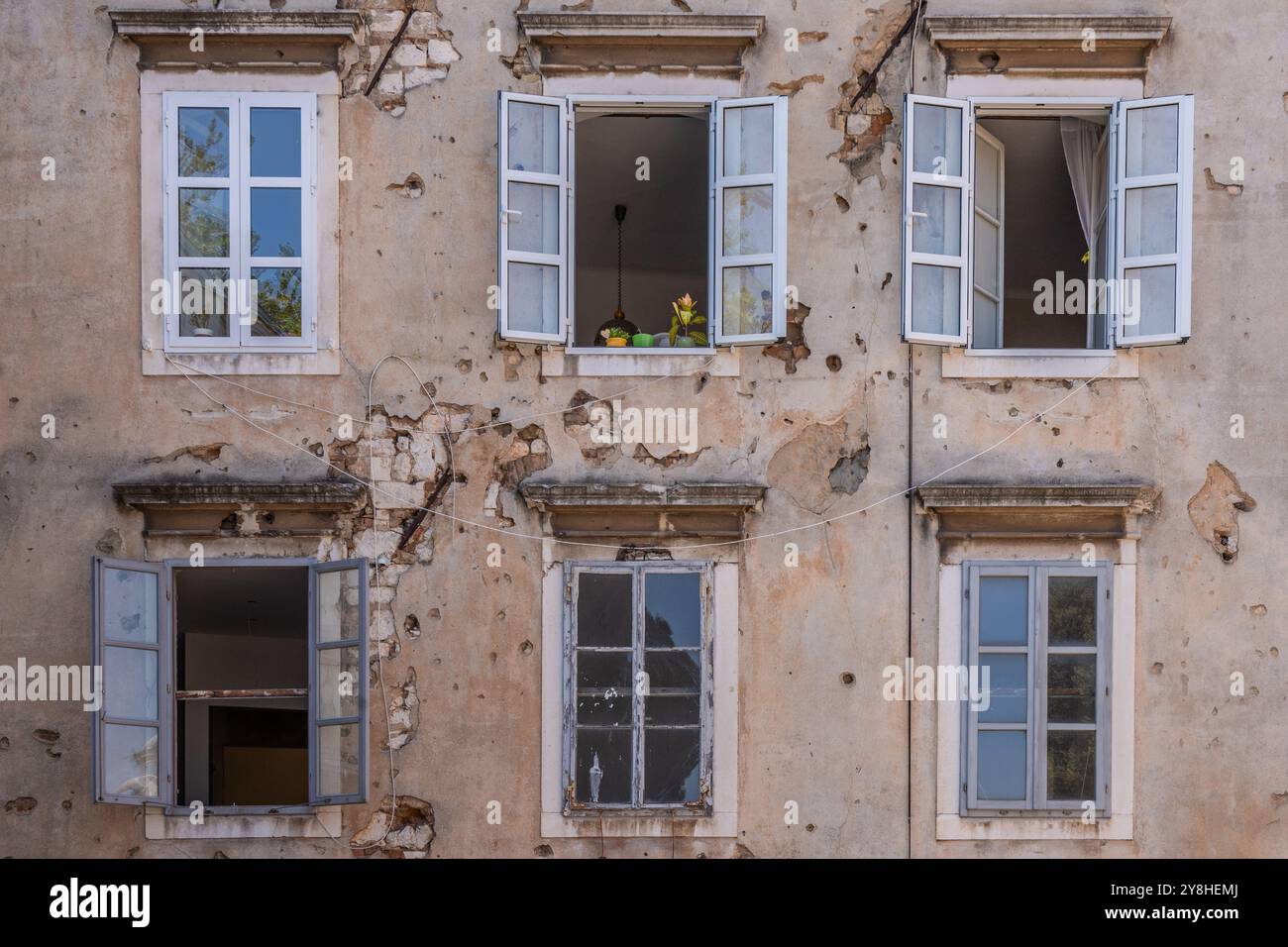 Window with bullet holes from the Balkan. Window facade of the historic ...