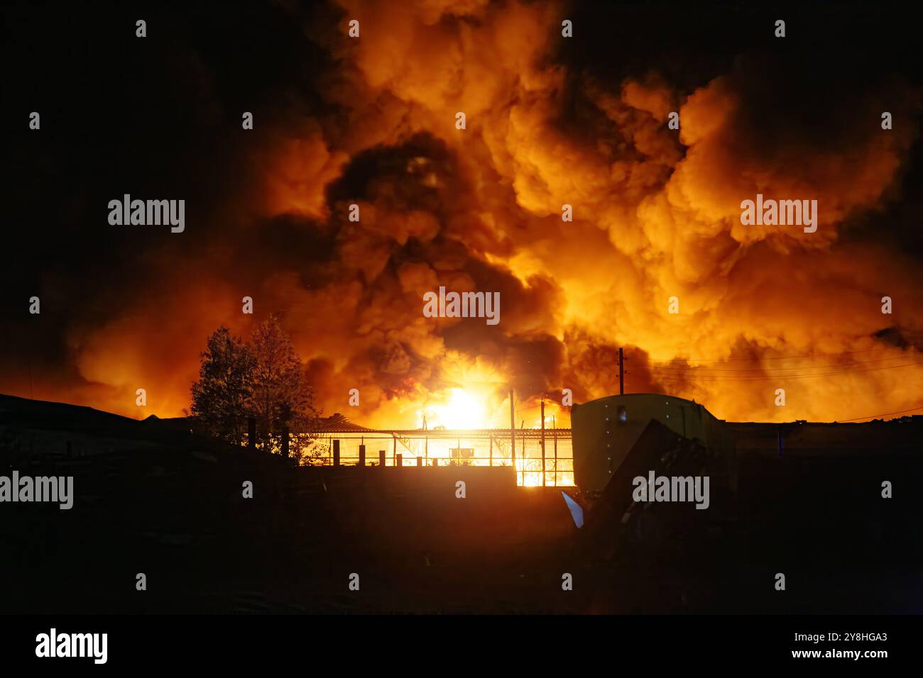 Burning industrial building. Big blaze and smoke at night Stock Photo ...