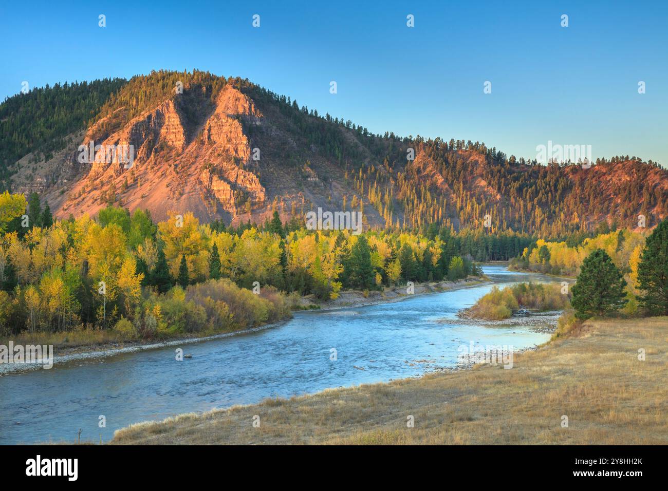 first light on cliffs above the blackfoot river in fall near ovando ...