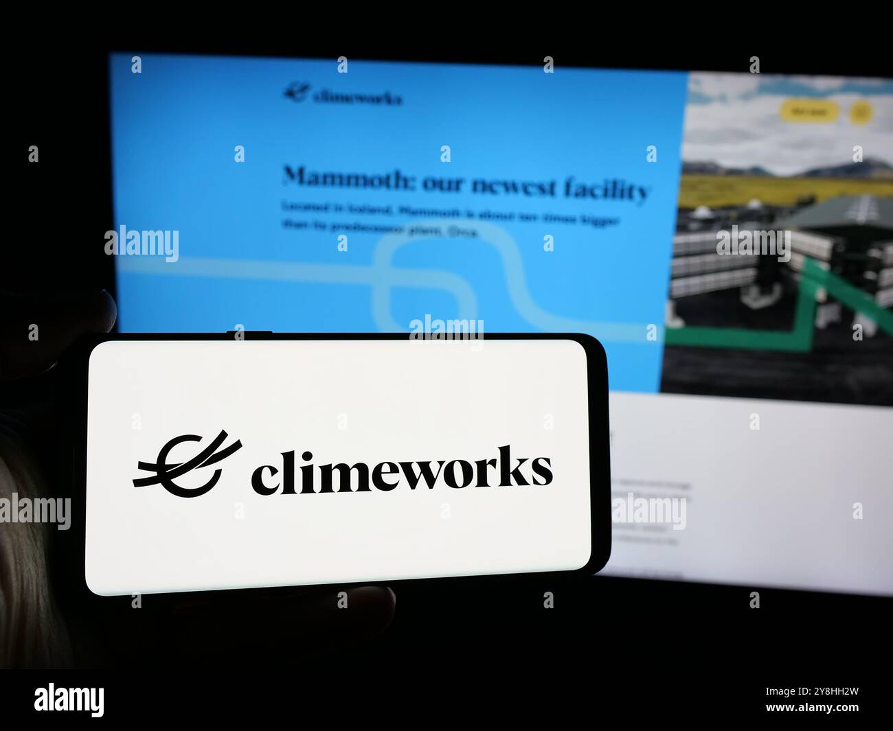 Person holding smartphone with logo of Swiss direct air capture company ...
