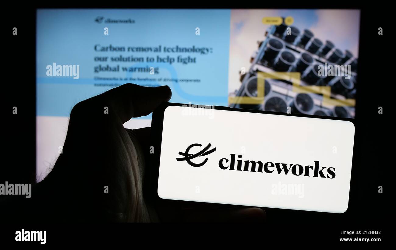 Person holding mobile phone with logo of Swiss direct air capture ...