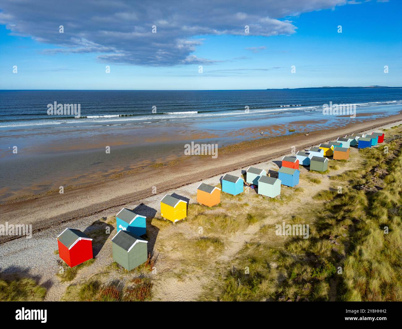 Aerial view from drone of colourful beach huts on beach at Findhorn on ...