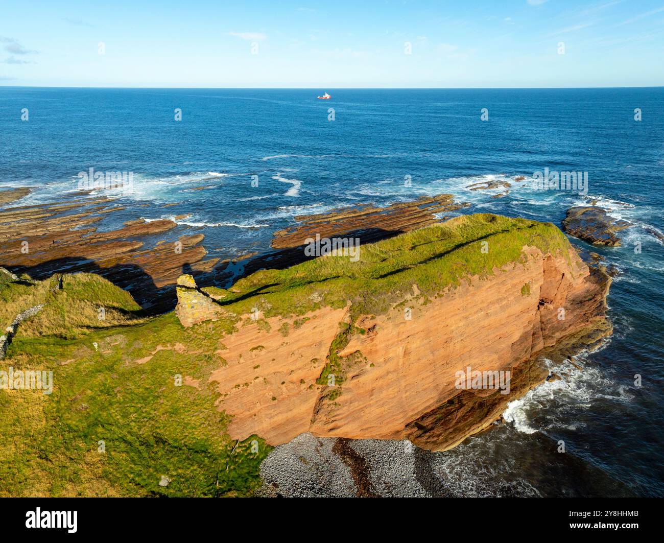 Aerial view from drone of ruins of Dundarg Castle on Aberdour Bay, on ...