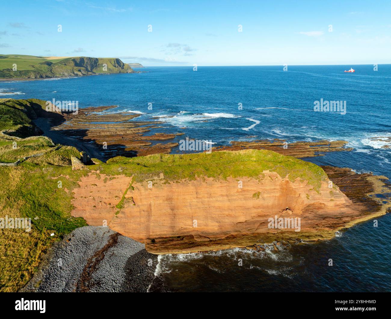 Aerial view from drone of ruins of Dundarg Castle on Aberdour Bay, on ...