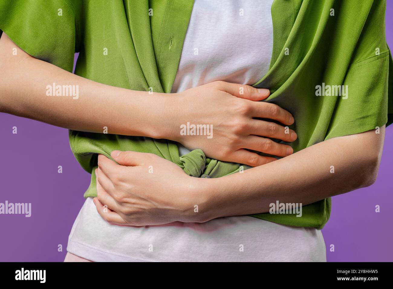 Young woman squeezing belly with hands. abdominal pain, suffering ...