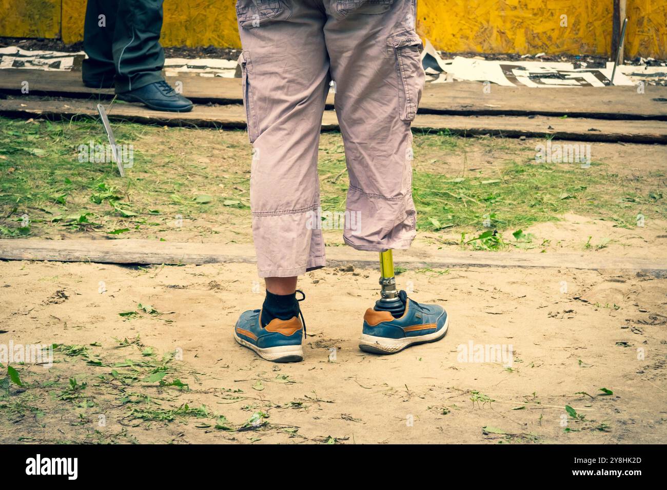 Sports and people with disabilities. A man without a leg throws knives ...