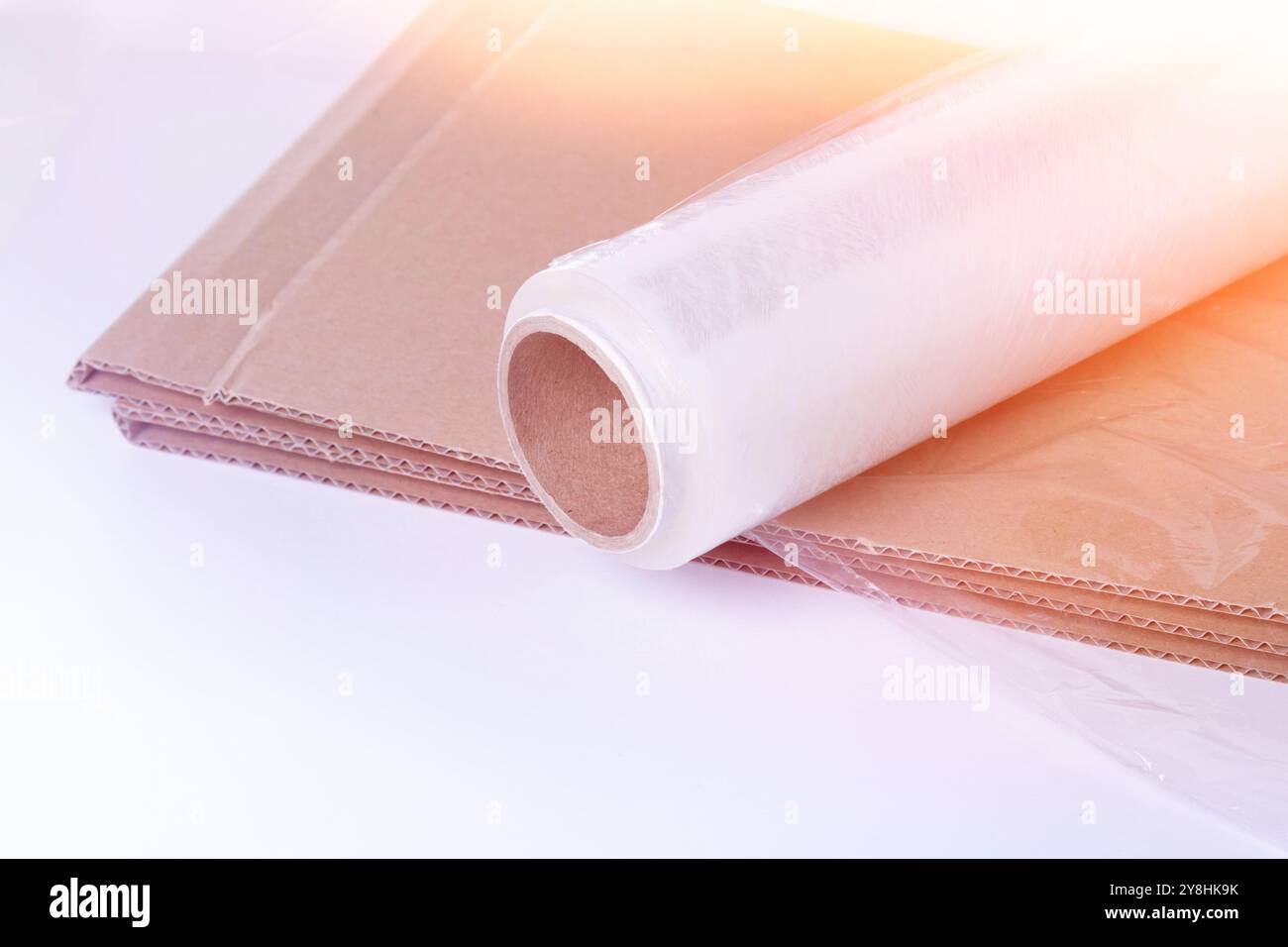 Stretch film and cardboard packaging on a white background top view ...