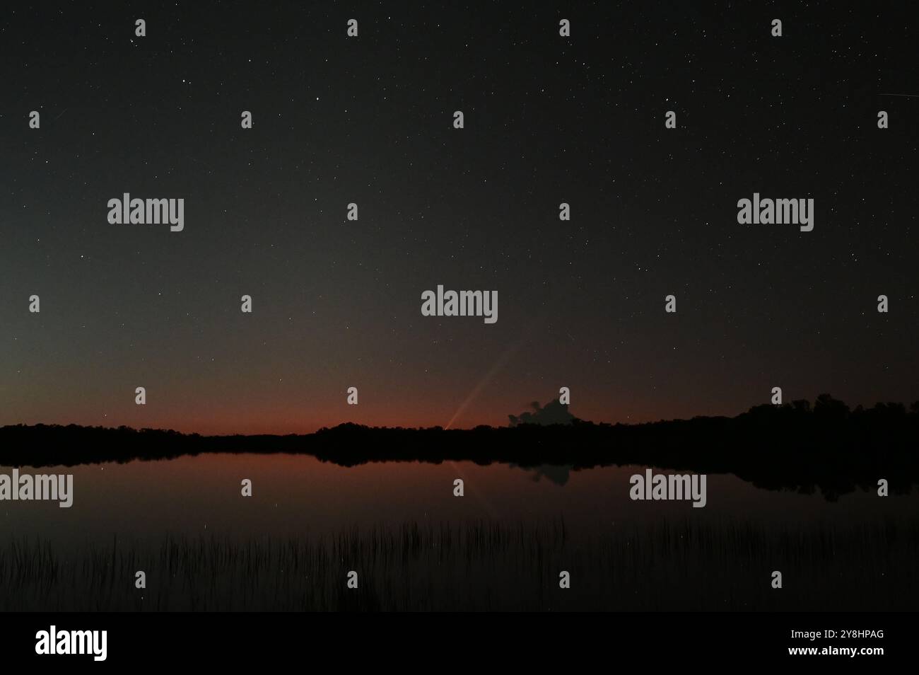 Comet Tsuchinshan-ATLAS rises in east over calm water of Nine Mile Pond ...