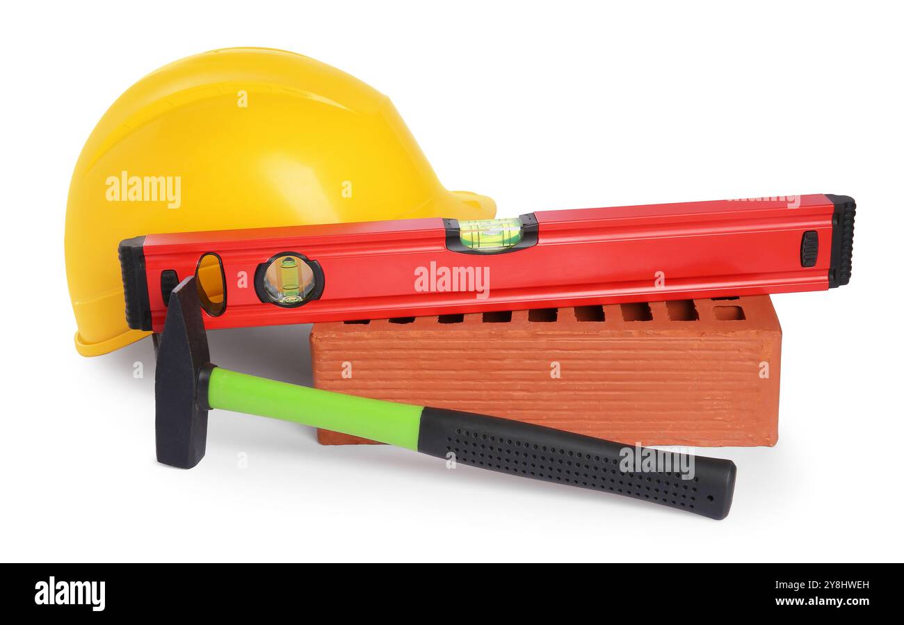 Yellow hard hat, building level, hammer and red brick isolated on white ...
