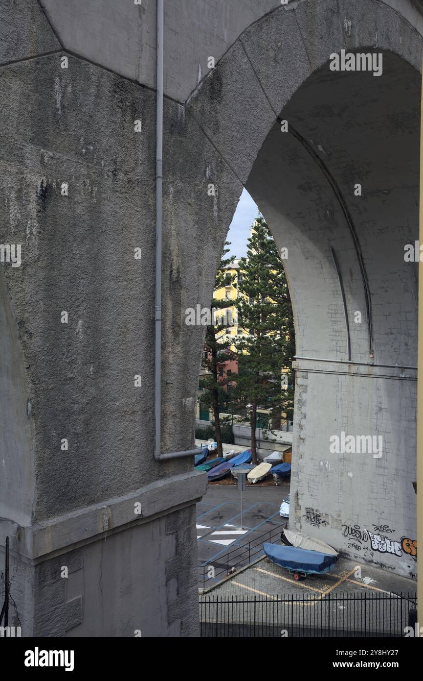 Square with covered boats on it under the arches of a viaduct in an ...