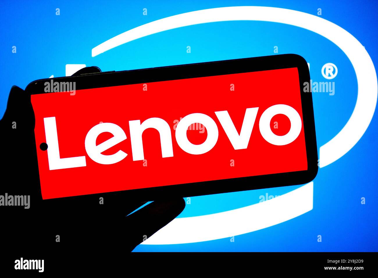 In this photo illustration, a Lenovo logo seen displayed on a ...
