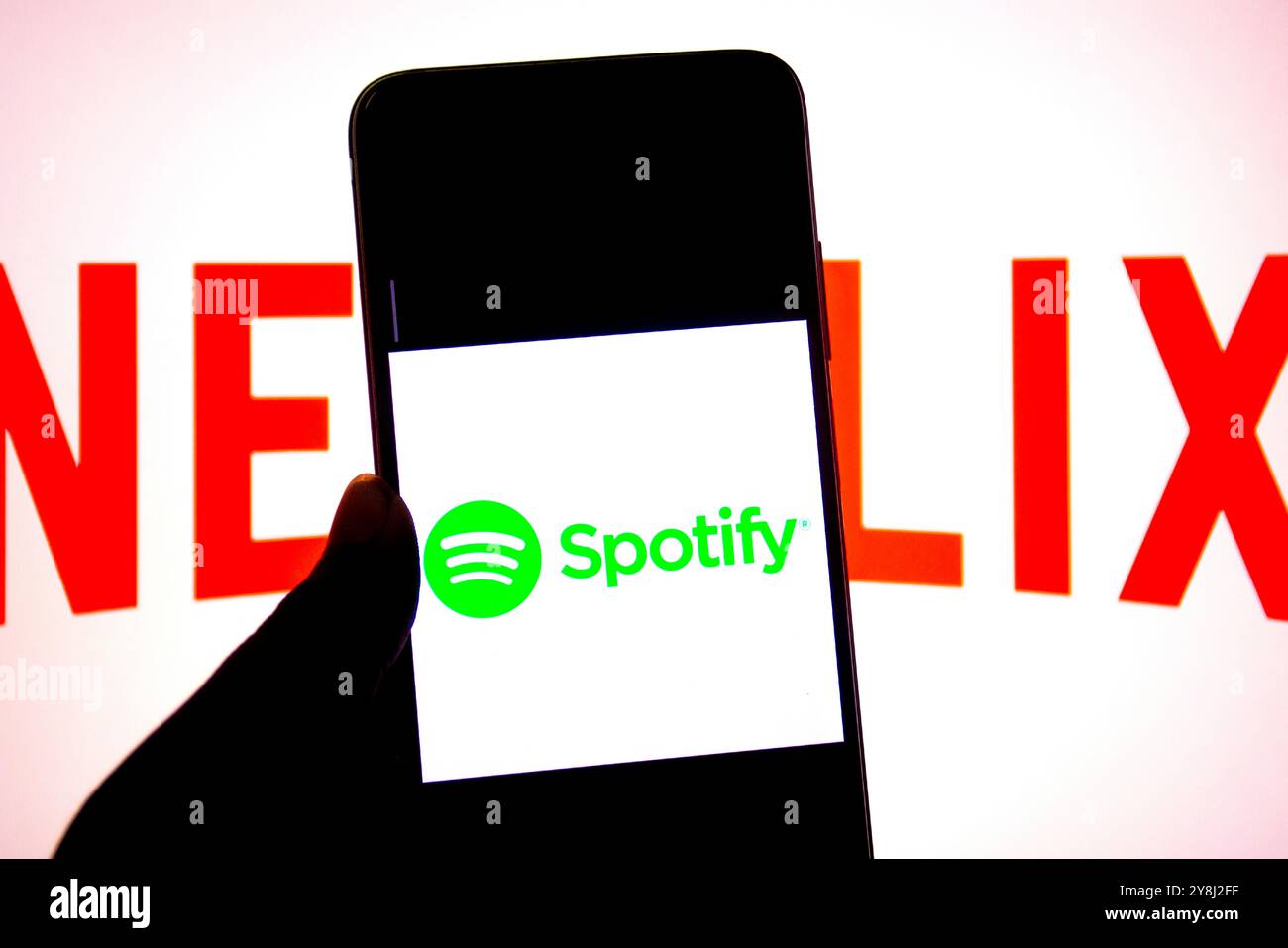In this photo illustration, a Spotify logo seen displayed on a ...