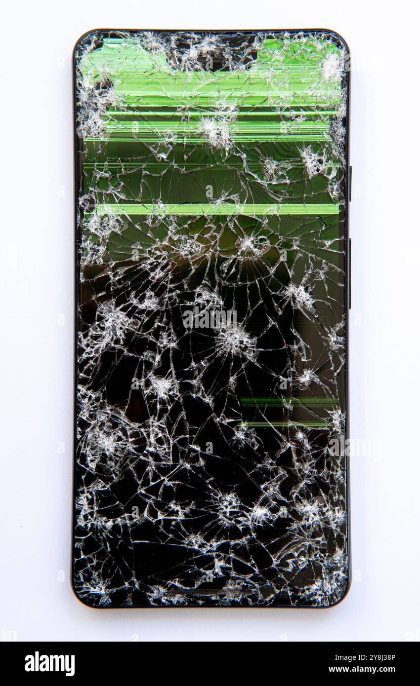 Smartphone with broken screen showing crack lines on the glass in close ...