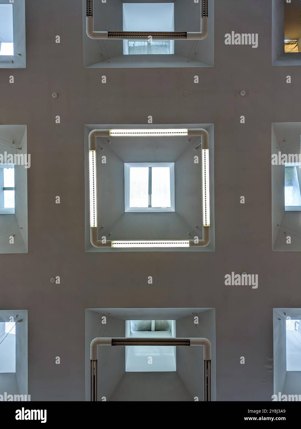 interior of a building viewed from below, looking upward. It features a ...