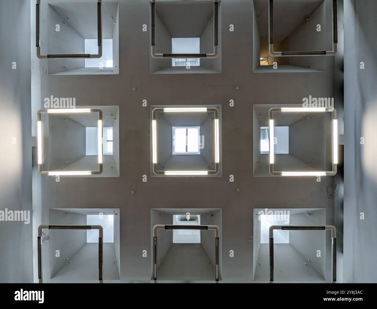 interior of a building viewed from below, looking upward. It features a ...