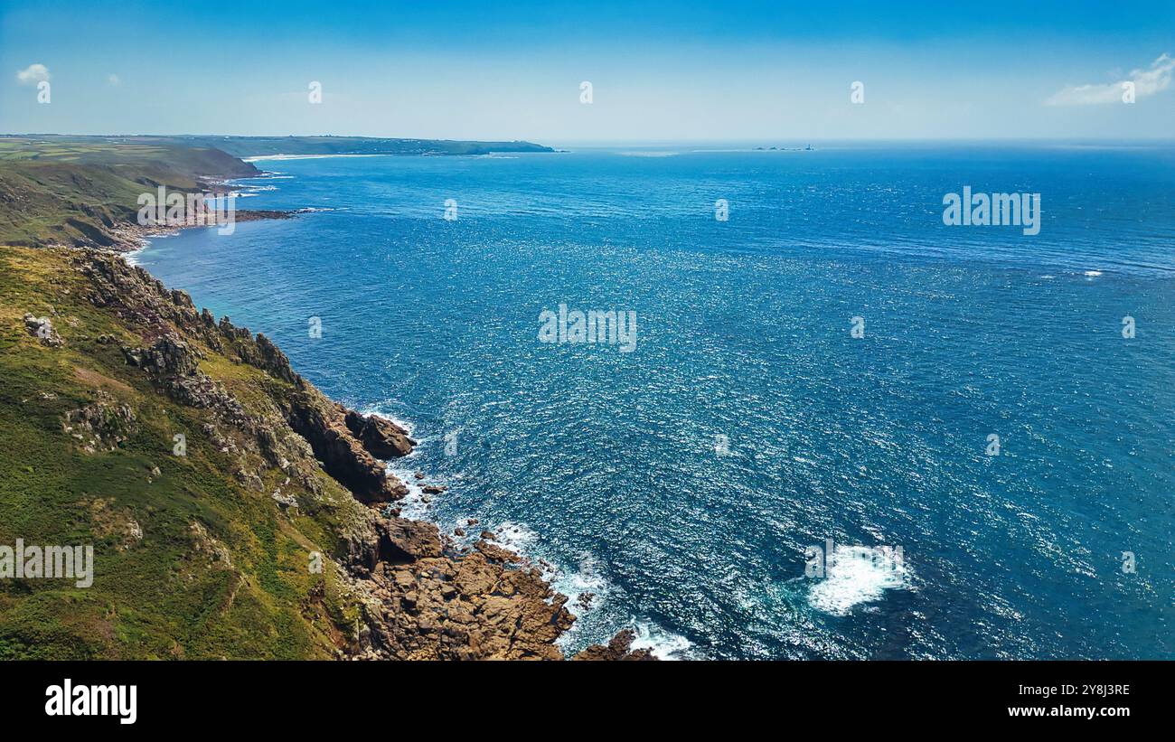 A stunning coastal view showcasing rugged cliffs and a vast blue ocean ...