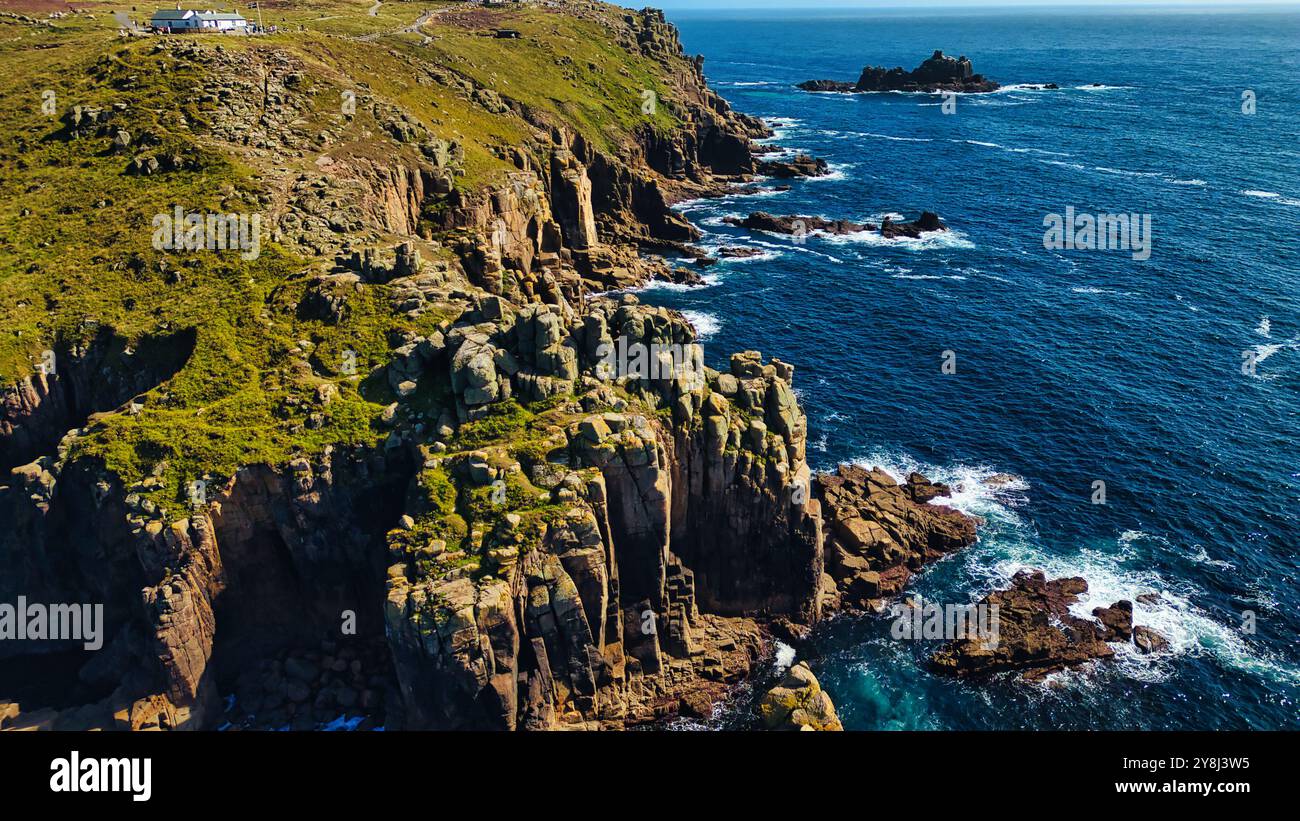 Aerial view of rugged coastal cliffs with lush greenery, overlooking ...