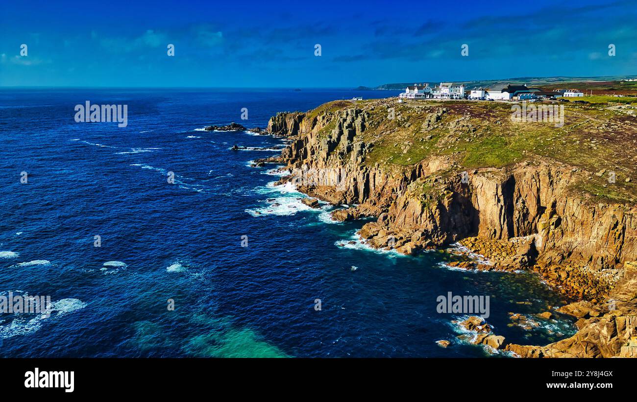 A stunning coastal view featuring rugged cliffs and a vibrant blue ...