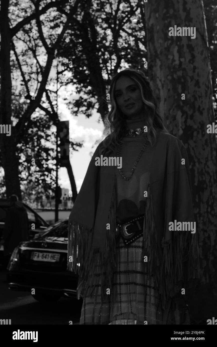 Cris Mata wearing turtle neck sweater, a plaid skirt, wrapped sweater ...