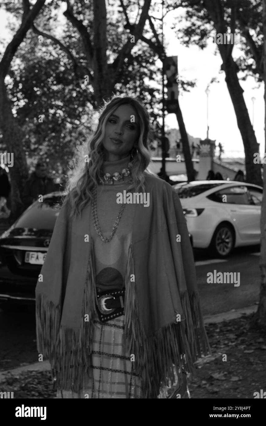 Cris Mata wearing turtle neck sweater, a plaid skirt, wrapped sweater ...