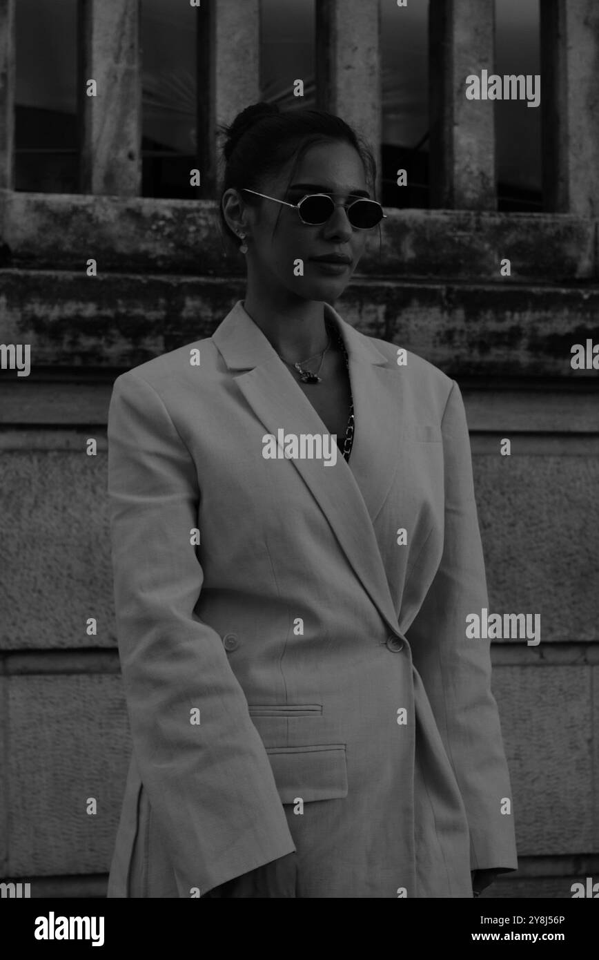 Rasha Al-Rifaie wearing a formal white 2 piece with an oversized blazer ...