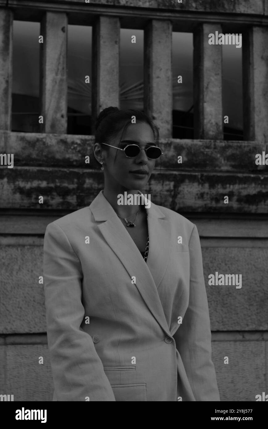 Rasha Al-Rifaie wearing a formal white 2 piece with an oversized blazer ...