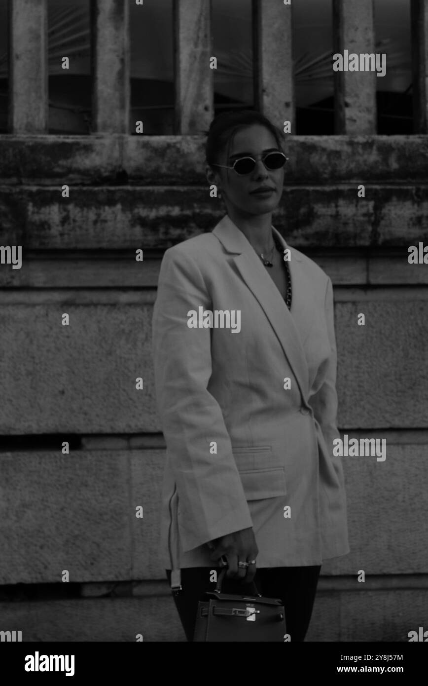 Rasha Al-Rifaie wearing a formal white 2 piece with an oversized blazer ...