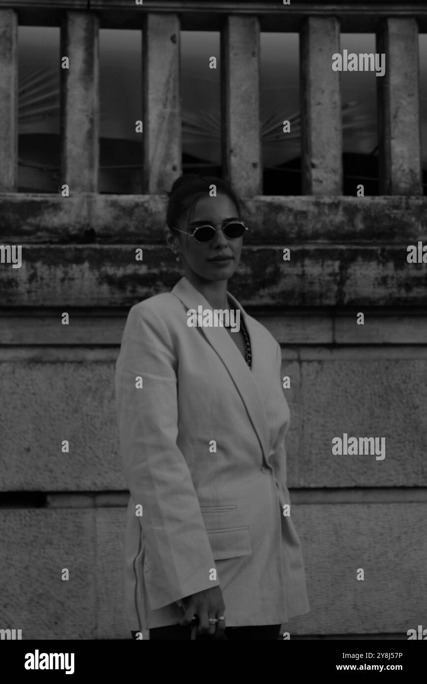 Rasha Al-Rifaie wearing a formal white 2 piece with an oversized blazer ...