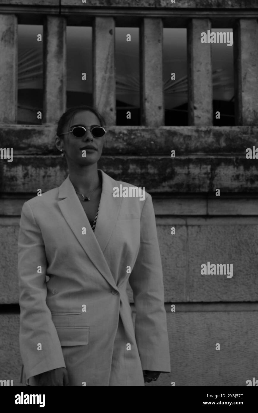 Rasha Al-Rifaie wearing a formal white 2 piece with an oversized blazer ...