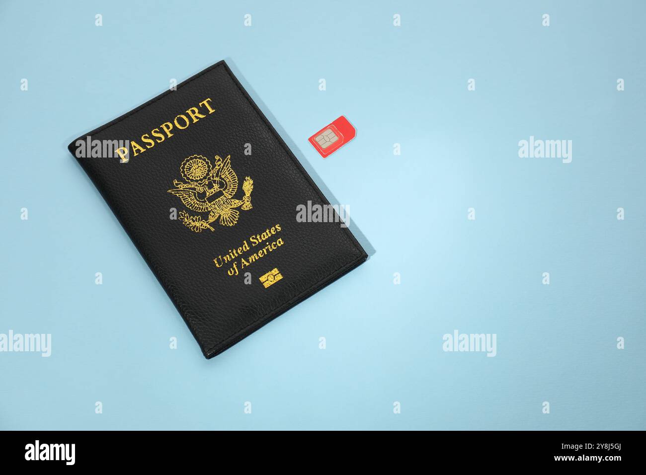 Modern SIM card and passport on light blue background Stock Photo - Alamy