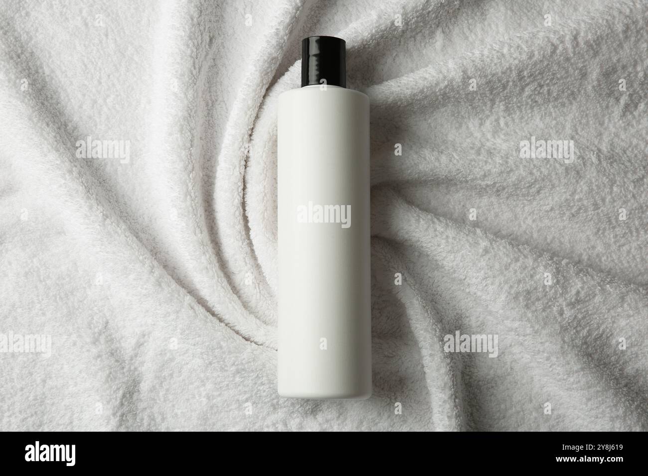 Bottle of shampoo on soft terry towel, top view Stock Photo - Alamy